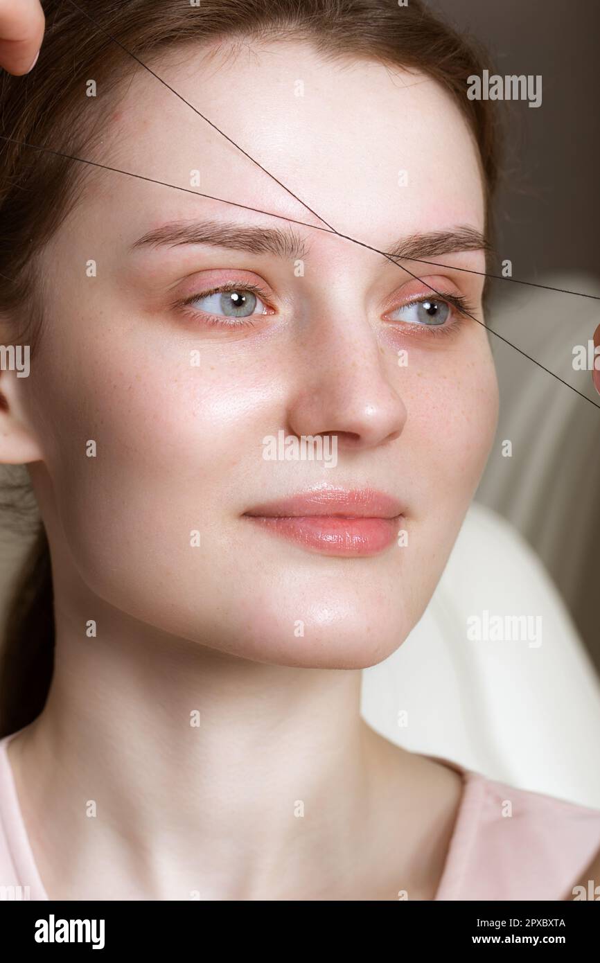 Permanent microblasting tattooing freckles to a woman in a beauty salon ...