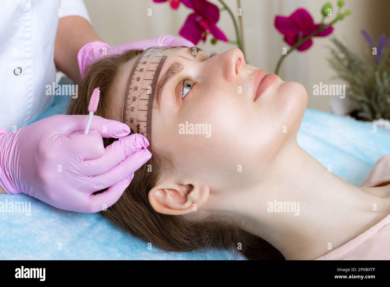 Permanent microblasting tattooing freckles to a woman in a beauty salon ...