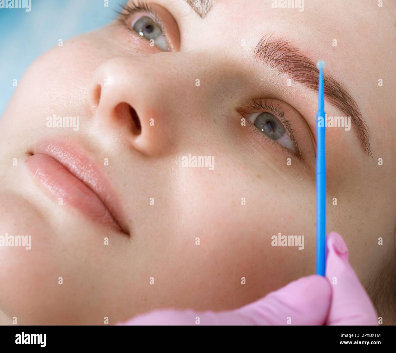 Permanent microblasting tattooing freckles to a woman in a beauty salon ...