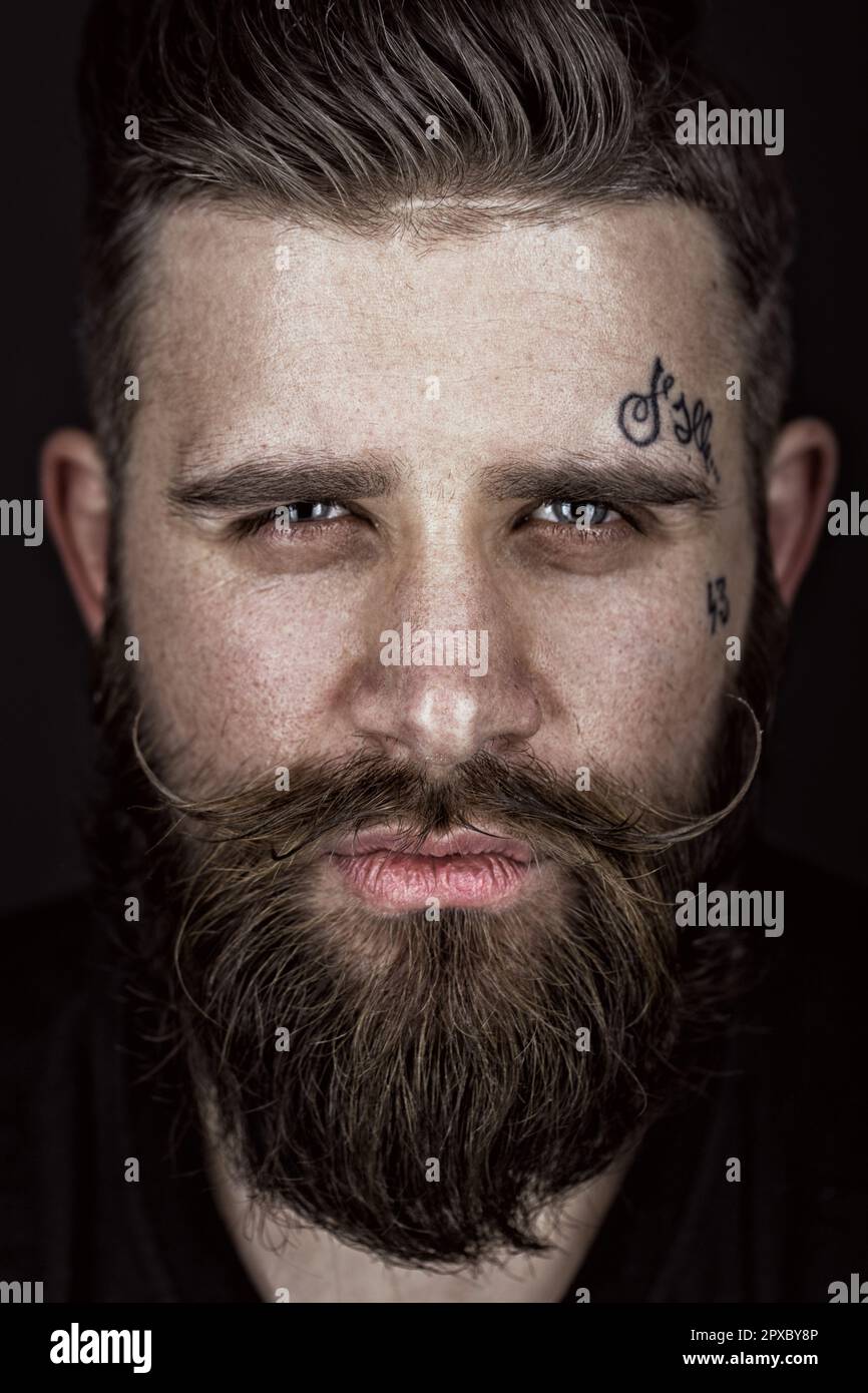 A solid man with a beard and mustache. Photos shot in the studio Stock ...