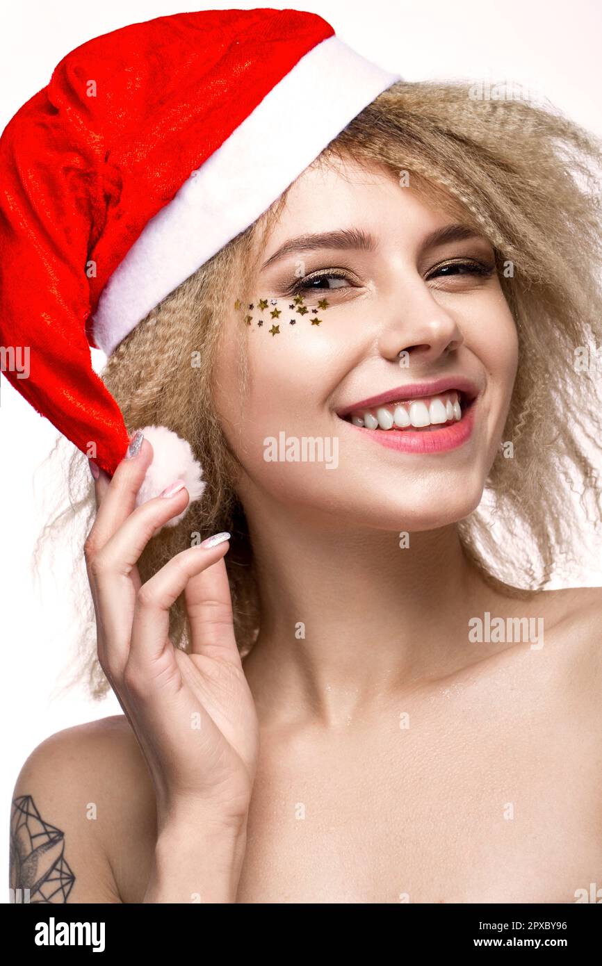 Jolly cheerful beautiful girl in a New Year's image with a festive make ...