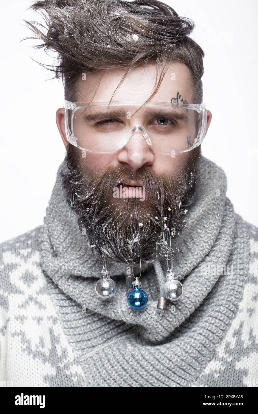 Funny bearded man in a New Year's image with snow and decorations on ...