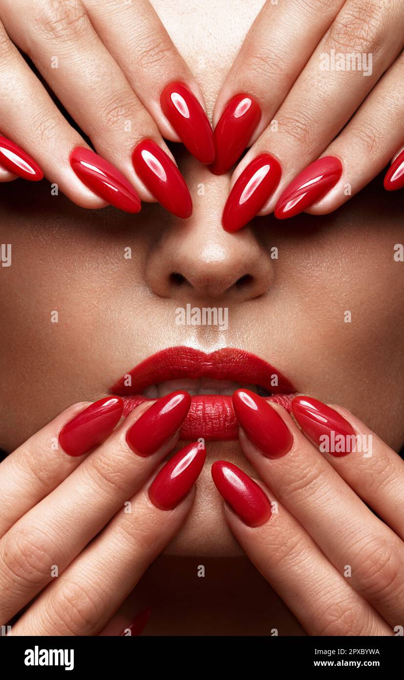 Beautiful girl with a classic make up and multi-colored nails. Manicure ...