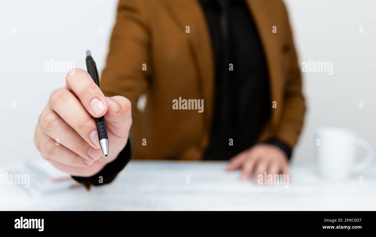 Male mode sitting at table And Pointing With Pen On Important Message ...