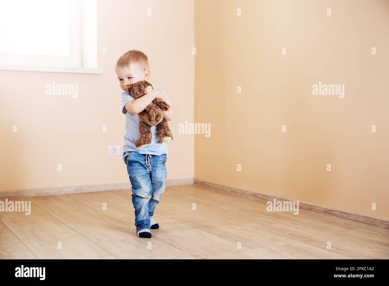 Cute boy sitting standing in empty room. Concept of family relocation ...