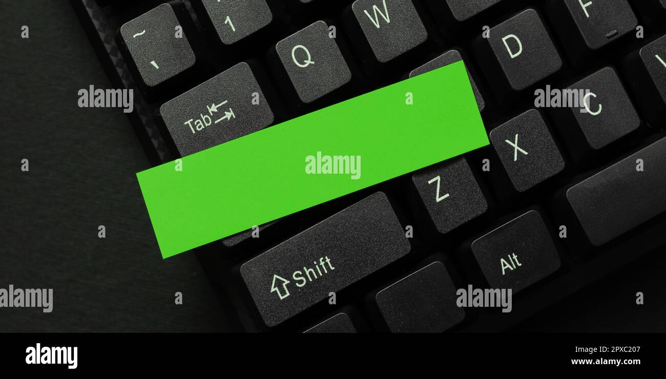 Sticker lying on black keyboard. Important message written over paper ...