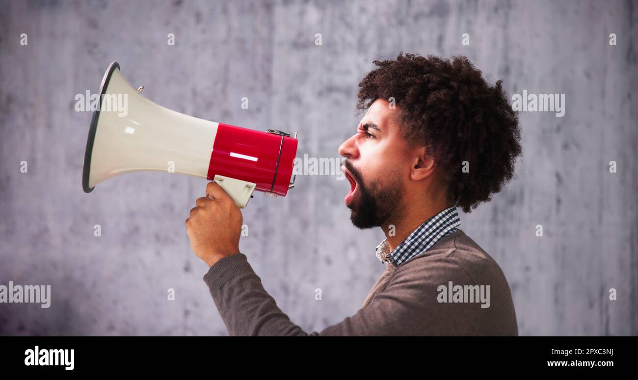 Man Making Announcement Using Megaphone Against Gray Background Stock ...