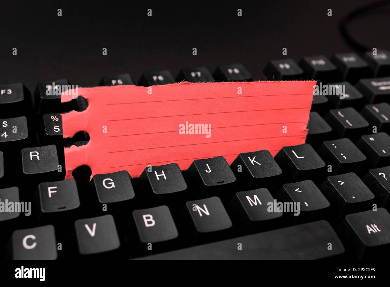 Colored sticker lying on keyboard. Important message written over paper ...