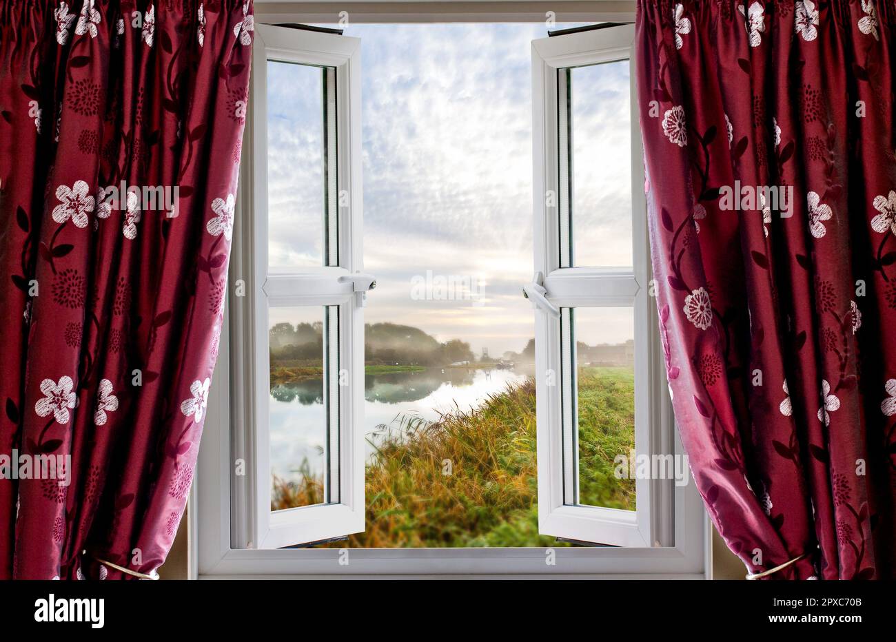 Beautiful rural view out of an open window with red curtains. Looking ...