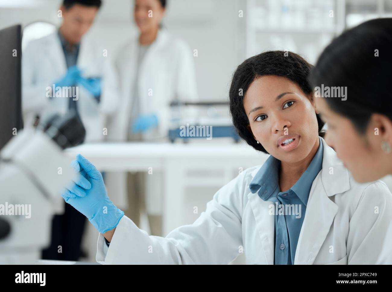 Female worker helping another worker hi-res stock photography and ...