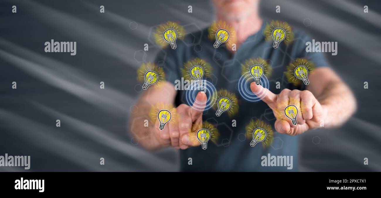 Man touching light bulbs on a touch screen with his fingers Stock Photo ...
