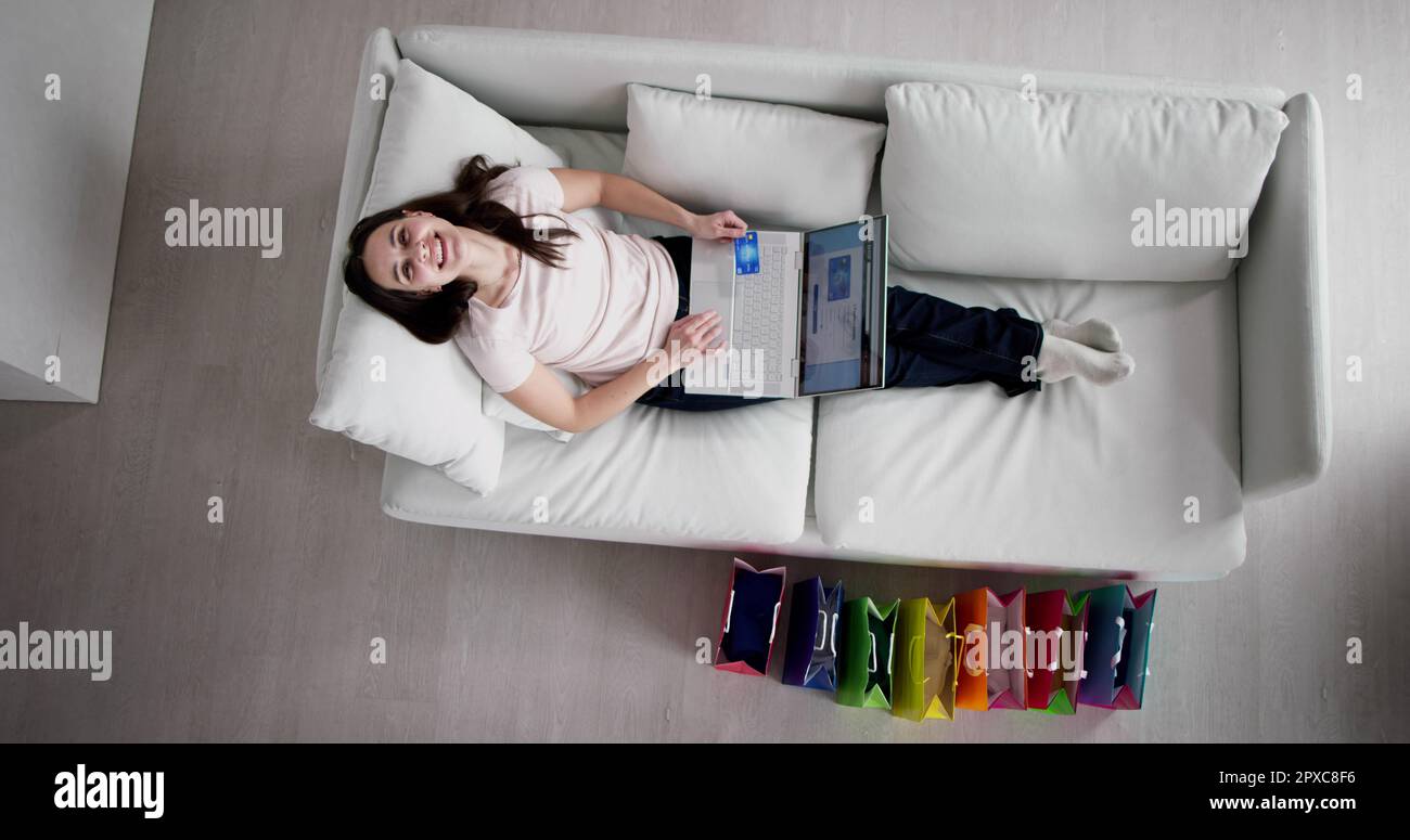 Online Laptop Shopper On Sofa. Top View Stock Photo - Alamy