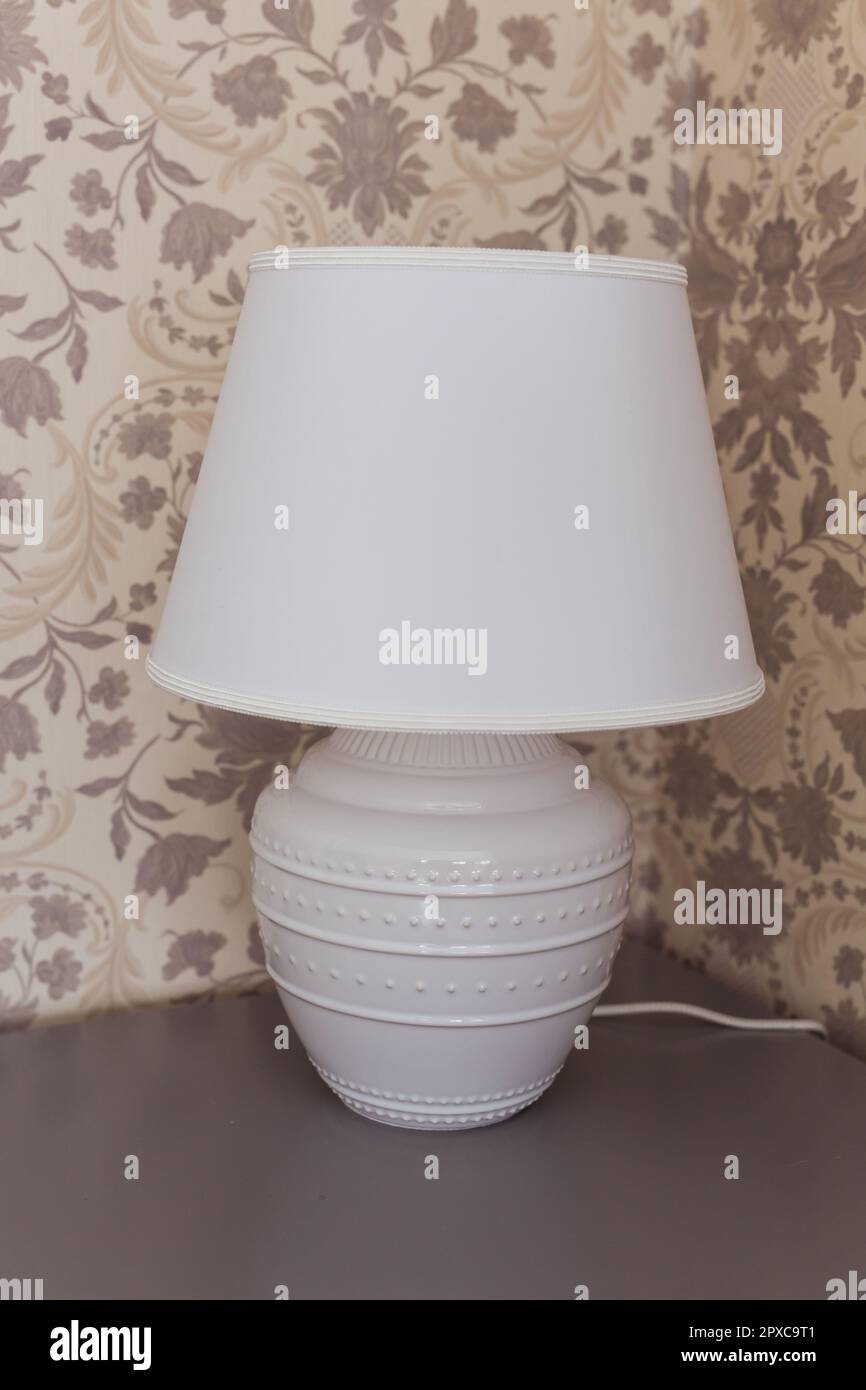 White lamp on the nightstand. Interior Stock Photo - Alamy