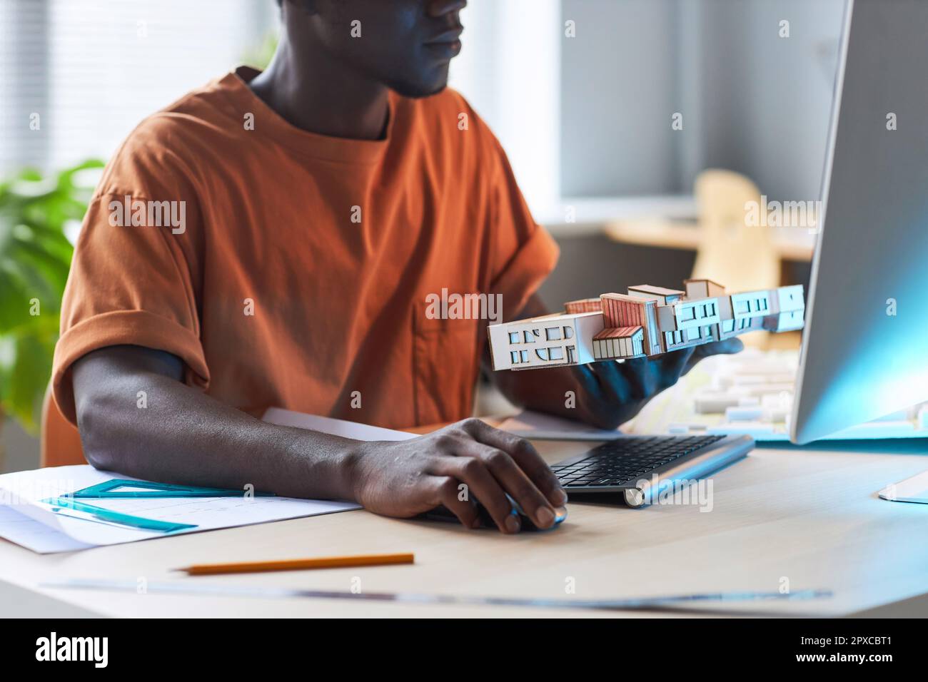 African American young engineer using computer to develop new ...