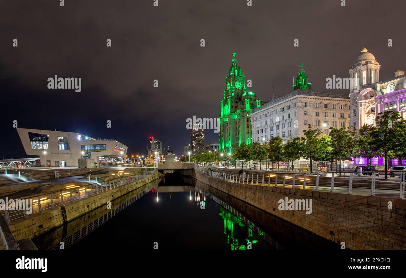 The Royal Liver Building lit up green at night alongside The Three ...