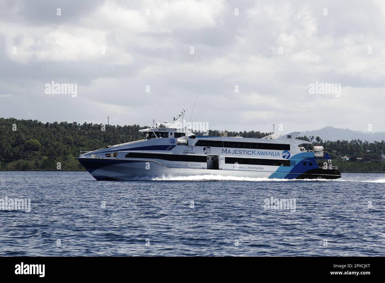 Fast ship sailing with hills in the background Stock Photo - Alamy
