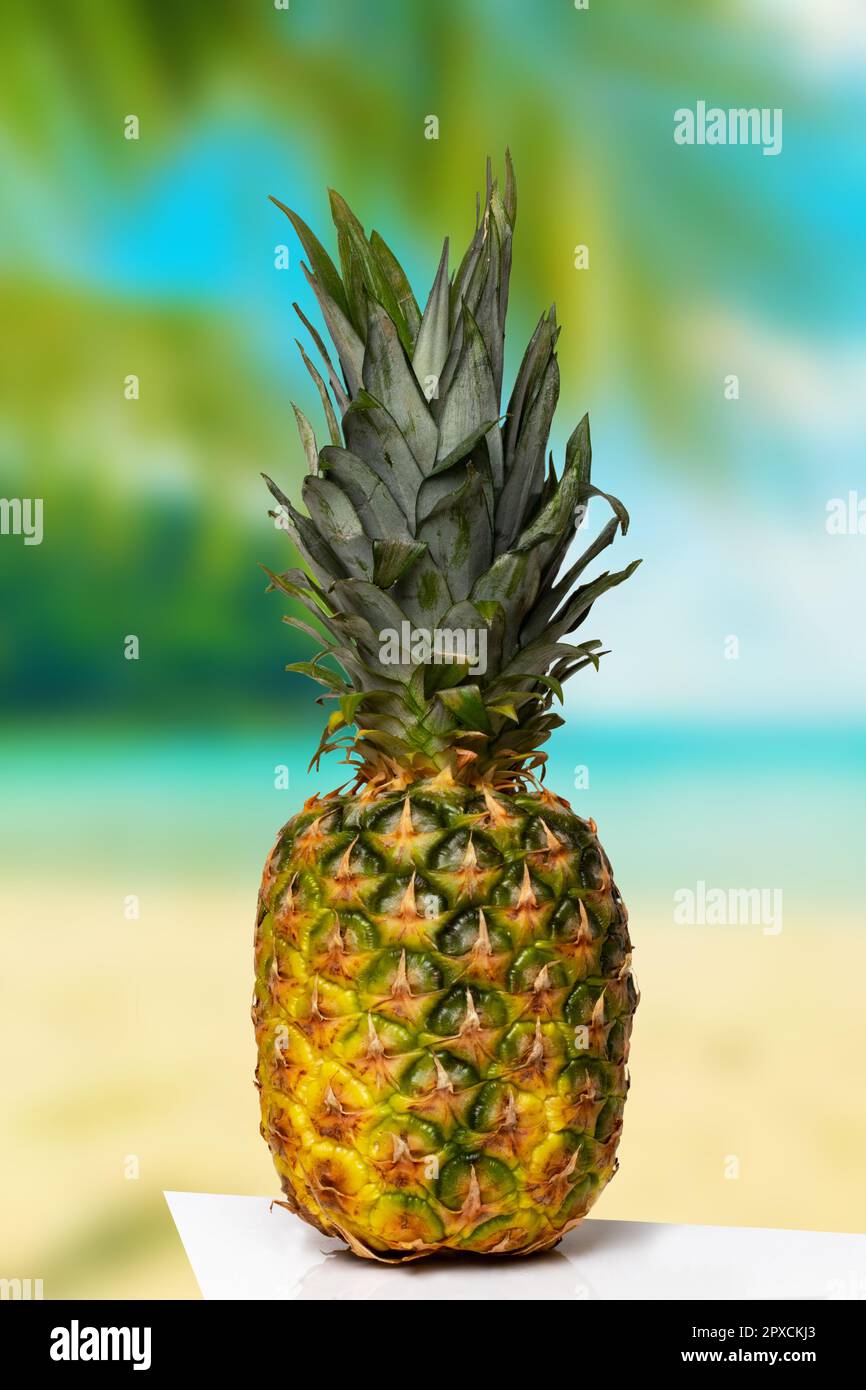 A beautiful fresh fruity pineapple on a table over abstract blurred ...