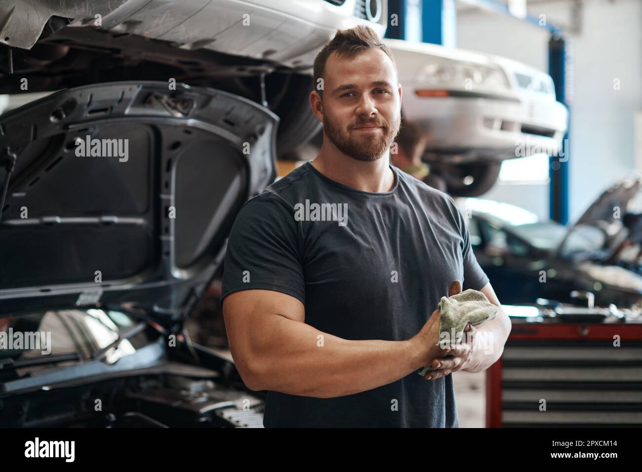 Making sure youre safe and secure on the road. a mechanic using a cloth ...