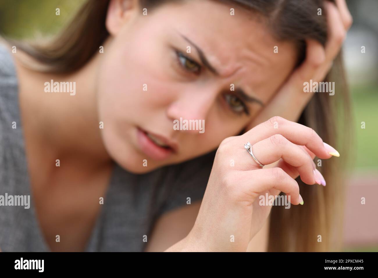 Sad teen looking at her engagement ring alone Stock Photo - Alamy