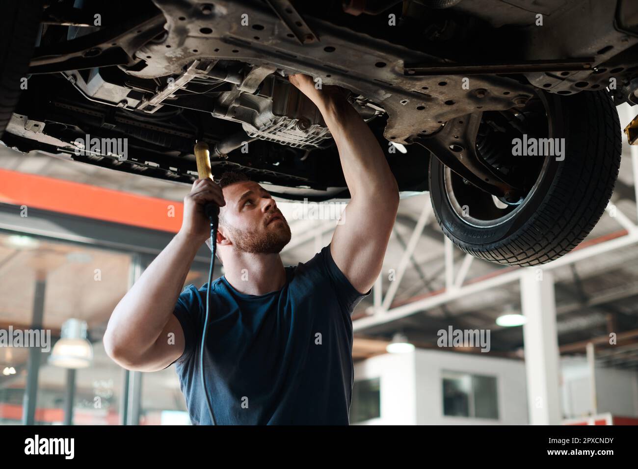 I got to the root of the problem. a mechanic working under a lifted car ...