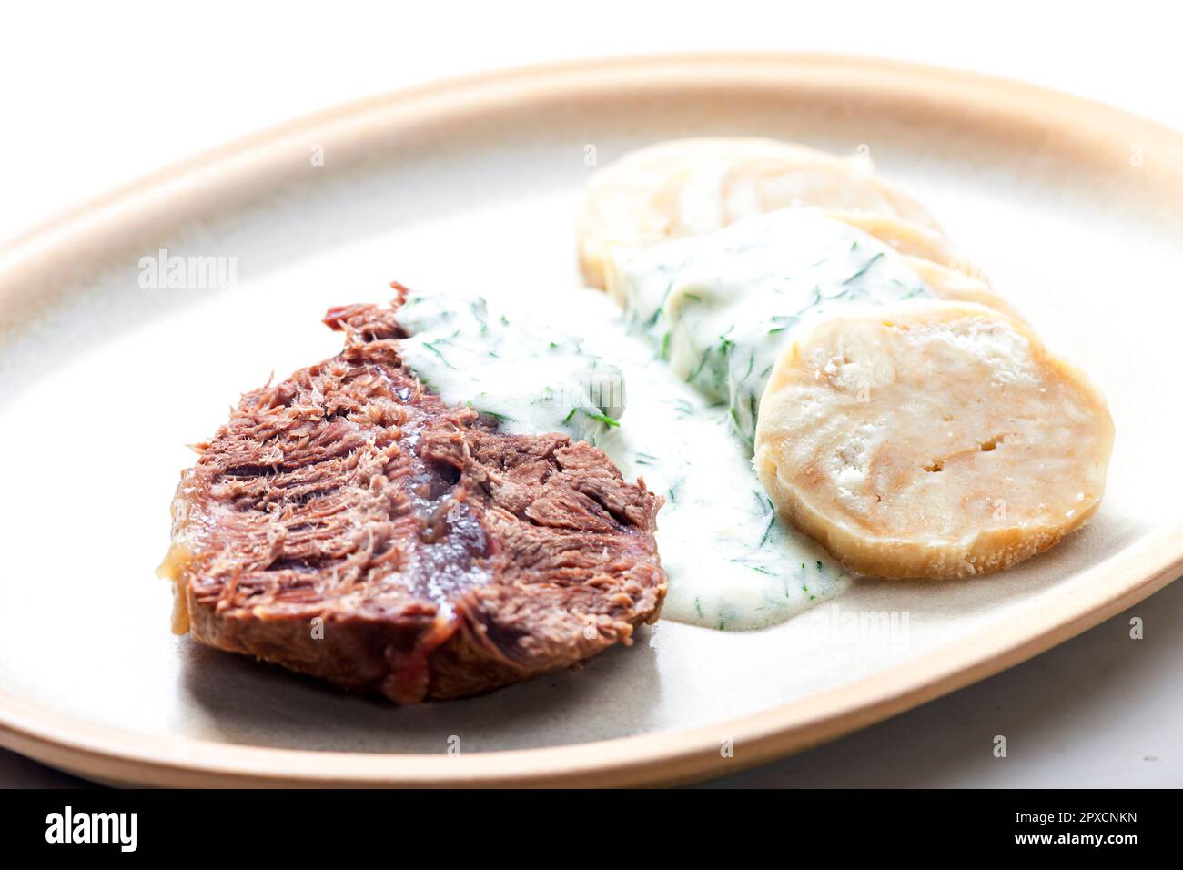 beef meat with dill sauce and dumplings Stock Photo - Alamy