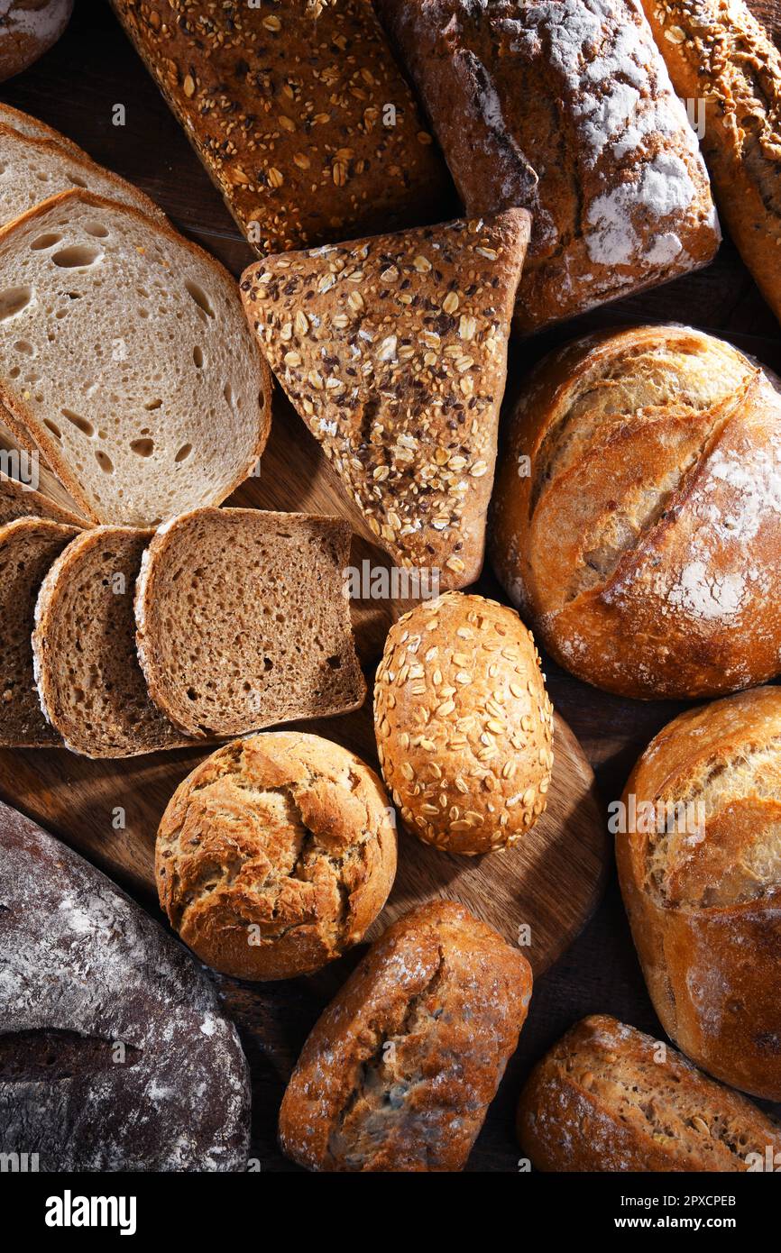 Assorted bakery products including loafs of bread and rolls Stock Photo ...