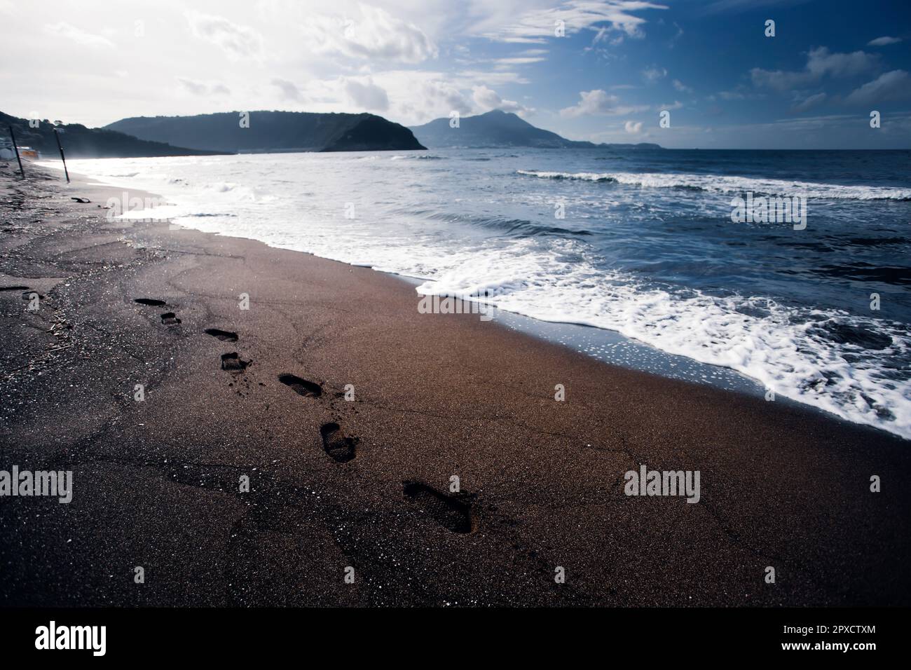 Footsteps in the sand on a beautiful italian beach Stock Photo - Alamy