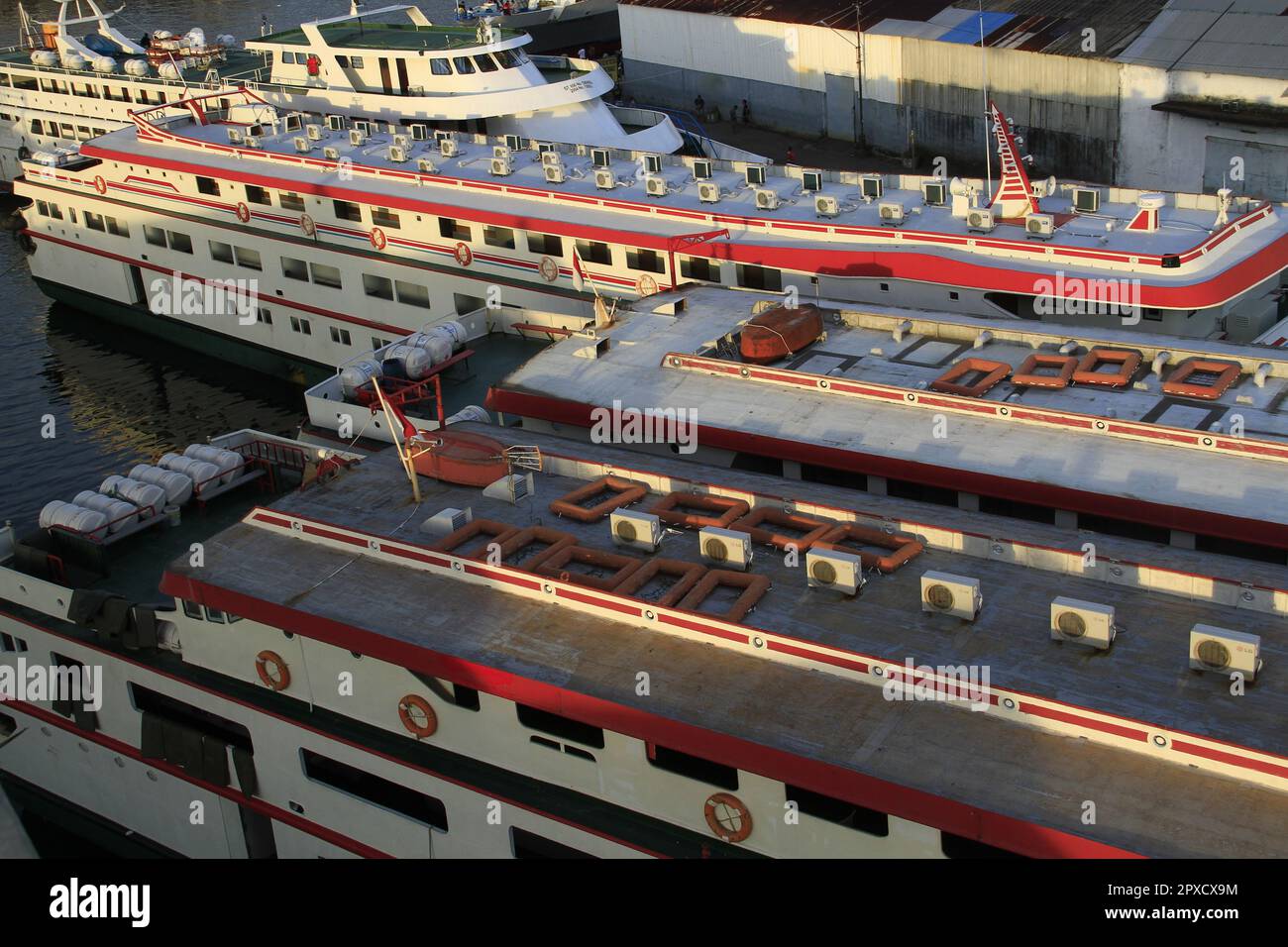 Ships are leaning on the harbor pier, side by side with each other ...