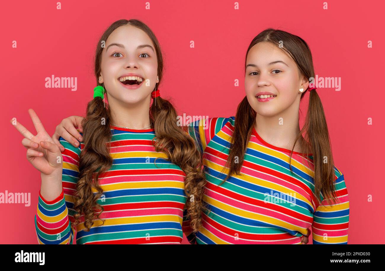 happy children embracing on pink background. peace Stock Photo - Alamy