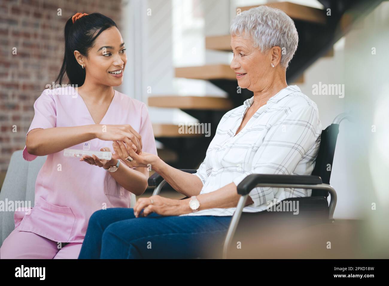 An oath of kindness. a young nurse caring for an older woman in a ...