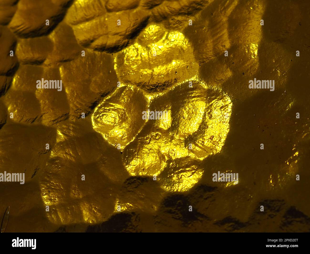 golden yellow corrugated glass with a light and dark background ...