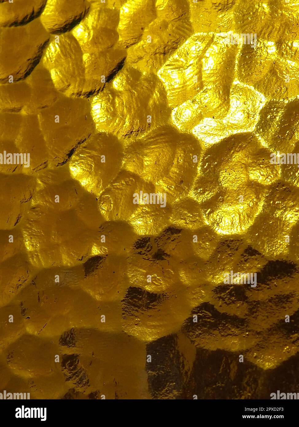 golden yellow corrugated glass with a light and dark background ...