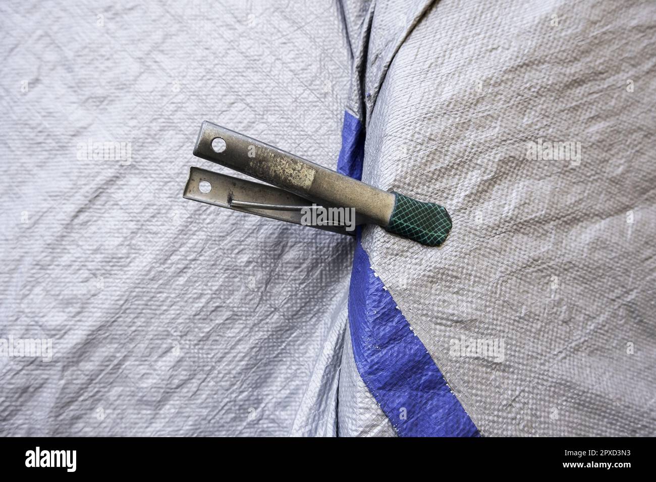 Detail of industrial metal clamp to grab fabric Stock Photo - Alamy