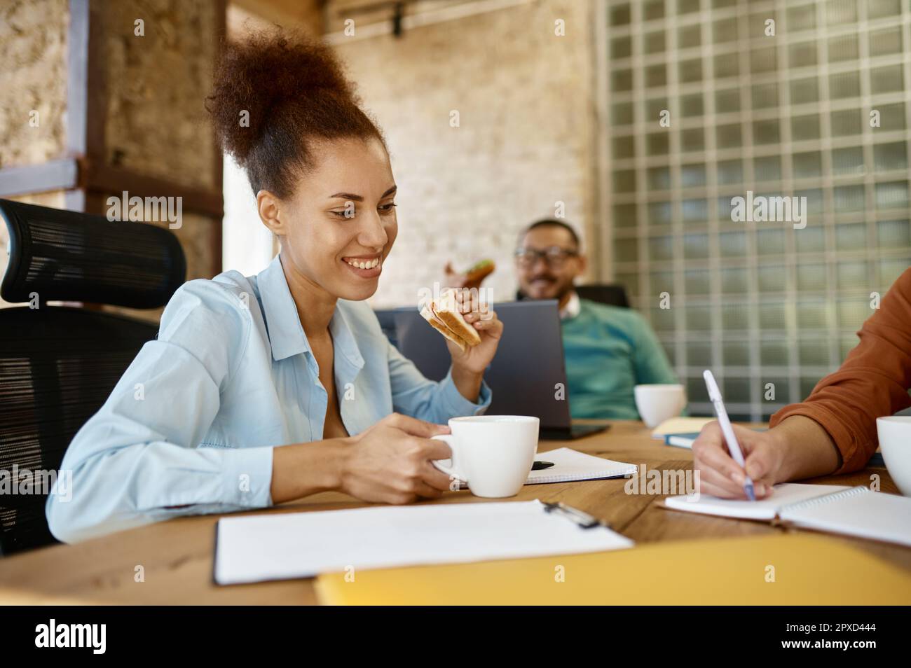 Multiracial marketing team having meeting during lunch time in ...