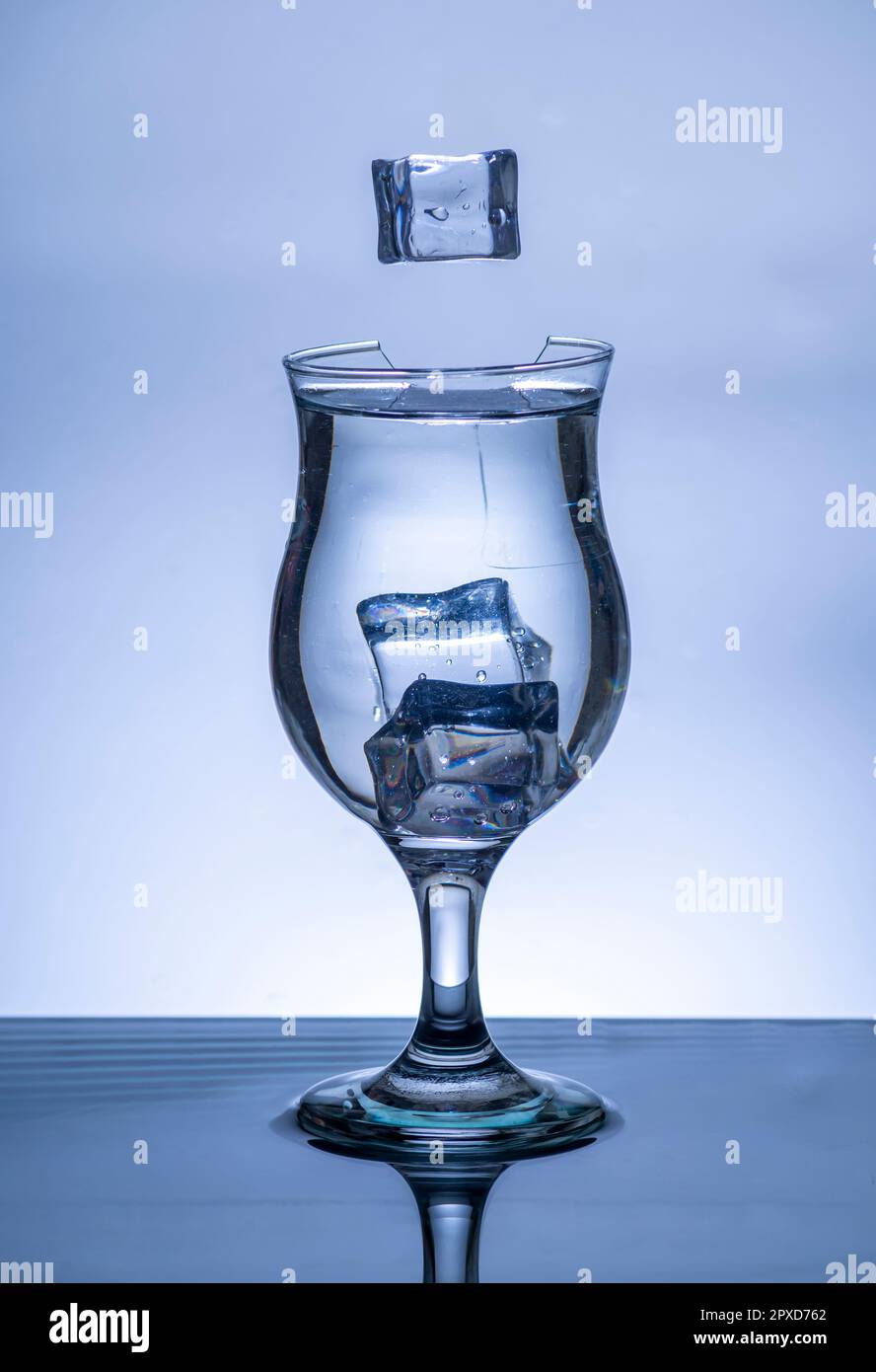 The image of pouring drinking water, into a broken glass, that makes ...