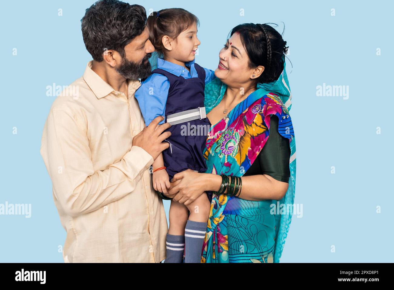 Young happy indian parents with her cute little girl wearing school ...