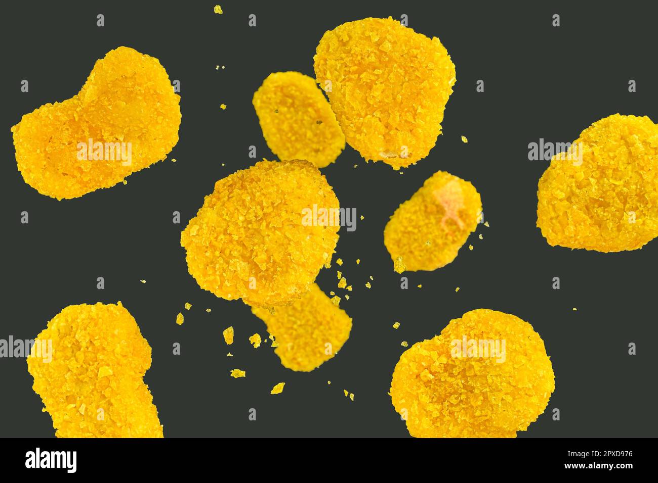 Freeze motion of flying chicken pieces on a black background. Flying ...