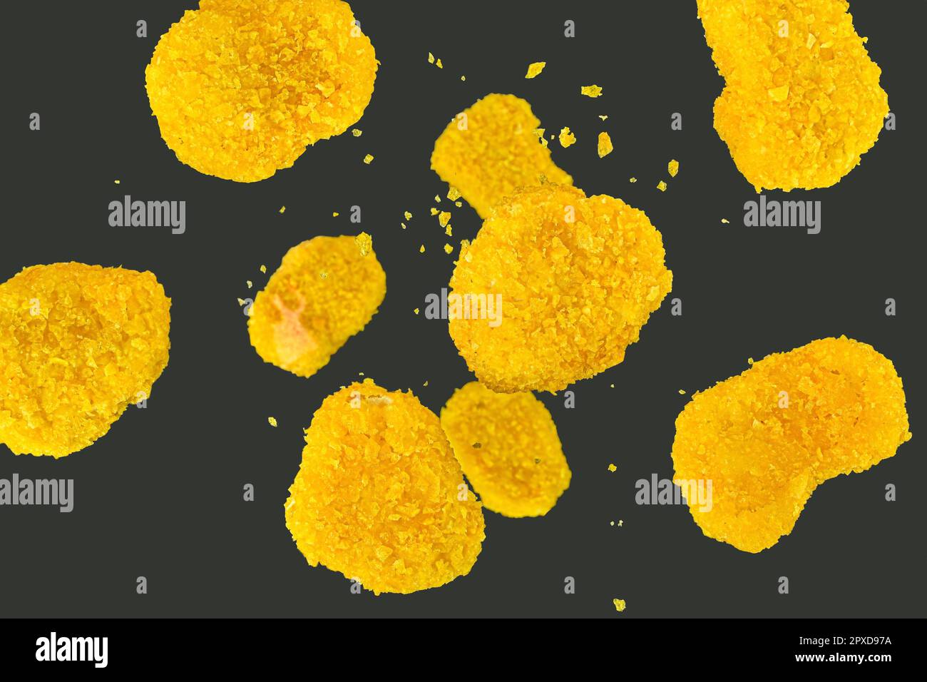 Freeze motion of flying chicken pieces on a black background. Flying ...