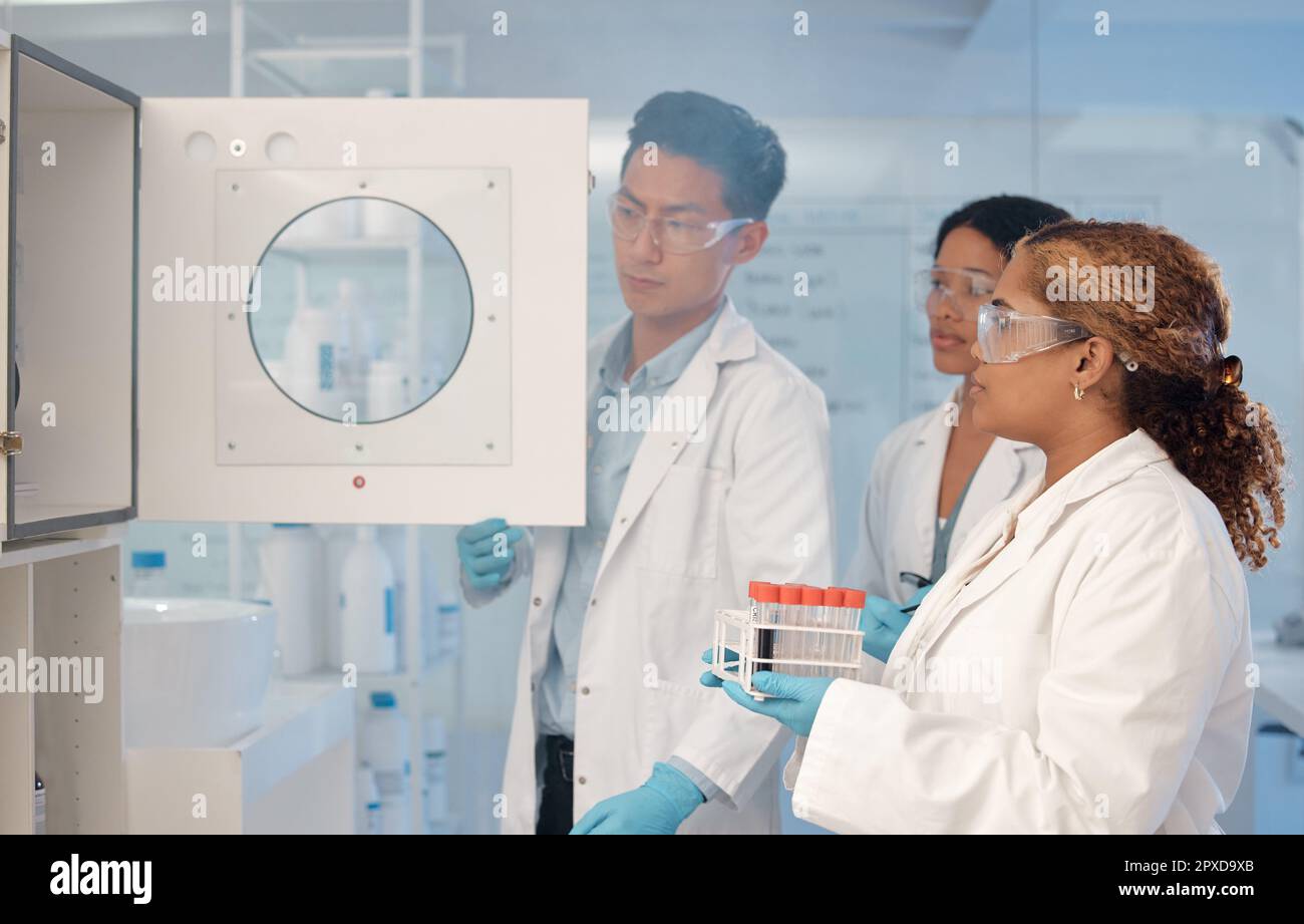 Are you ready for this. a group of scientists inserting a tray of ...