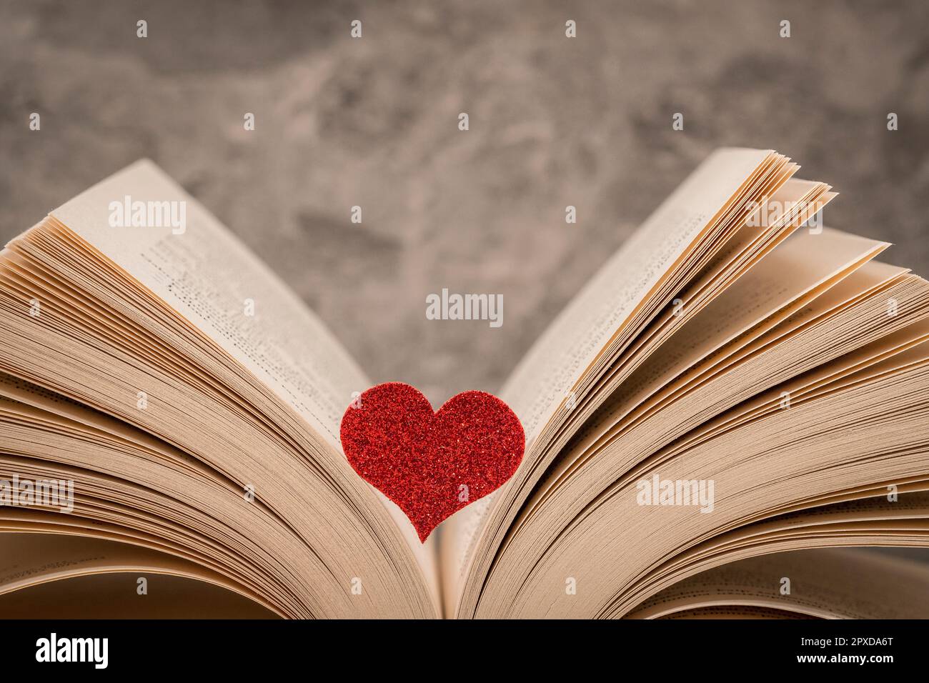 Red heart on open book in relaxation and cozy mood. Image for education ...