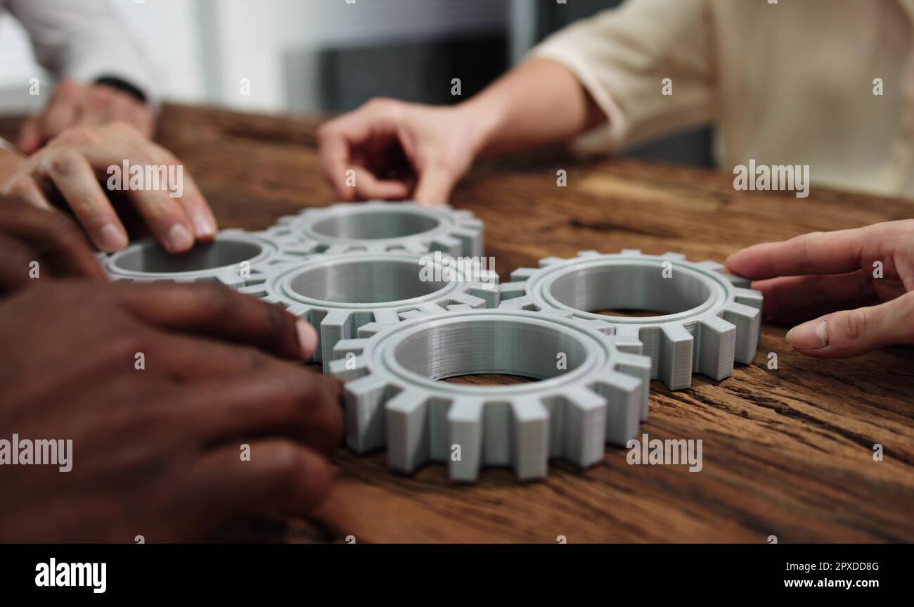Hands Holding Interlocked Gear Wheels. Business Partnership Stock Photo ...
