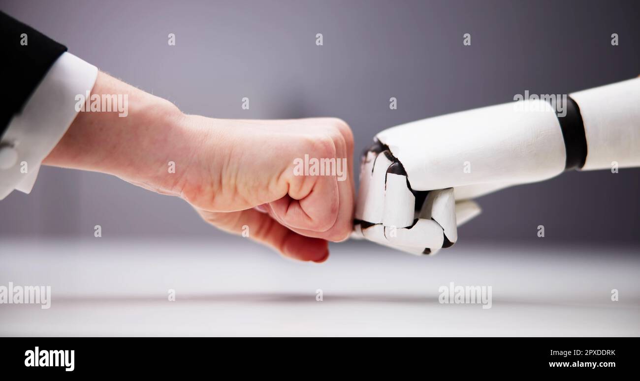 Robot And Human Hand Making Fist Bump On Grey Background Stock Photo ...