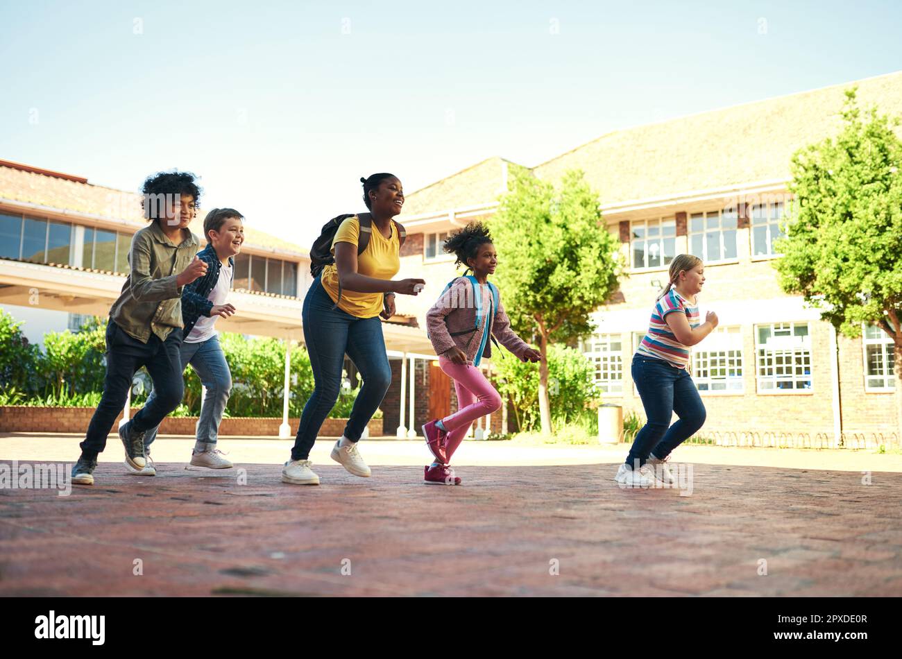 Race you back to class. Full length shot of a diverse group of children ...
