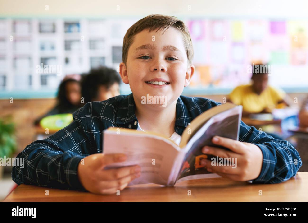 My love of reading developed in school. a young boy sitting in his ...