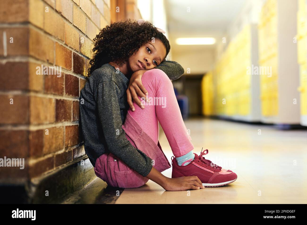 I feel so alone at school. Full length shot of a young girl sitting ...