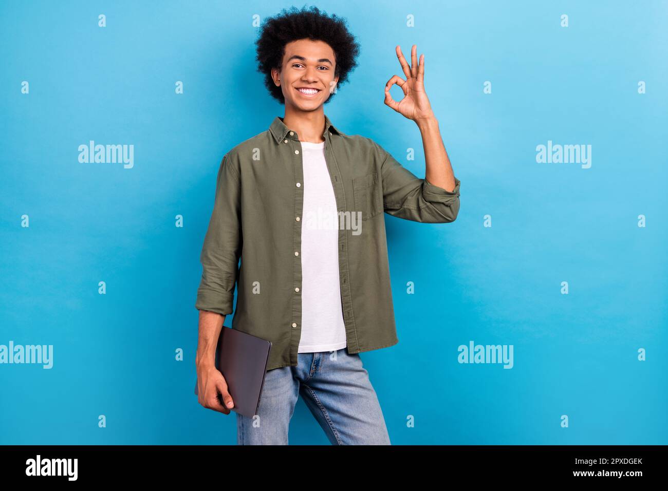 Photo of handsome person hold netbook demonstrate okey symbol approval ...