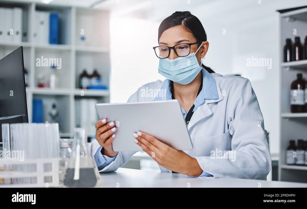 Work made easier by technology. a young female researcher using a ...