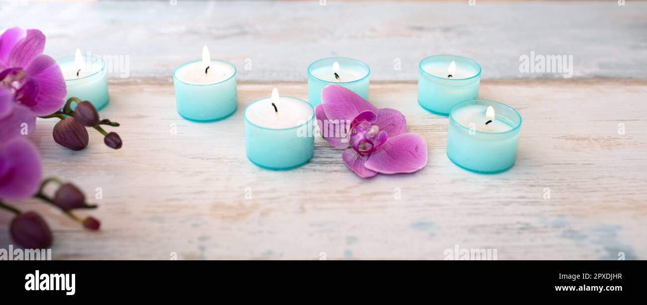 Spa decoration with purple orchids and candle lights on gray vintage ...