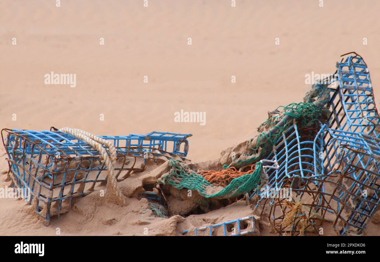 Lobster pots and nets washed up on beach Stock Photo - Alamy