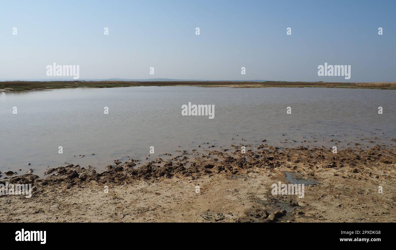 Crater with gray volcanic healing clay. A hole with a prominent ...